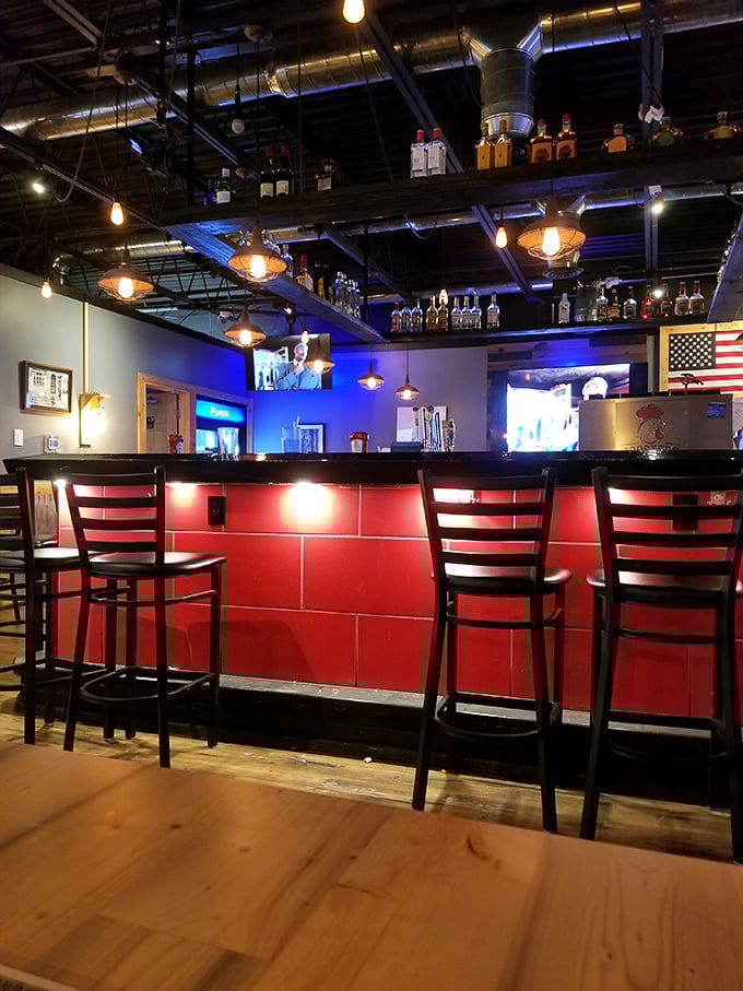 The bar area combines industrial chic with hometown warmth—exactly where you want to perch while debating which wing sauce deserves your eternal loyalty.