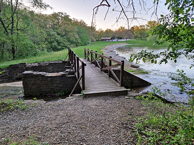 This rustic bridge isn't just crossing water—it's connecting you to the simpler side of life waiting on the other bank.