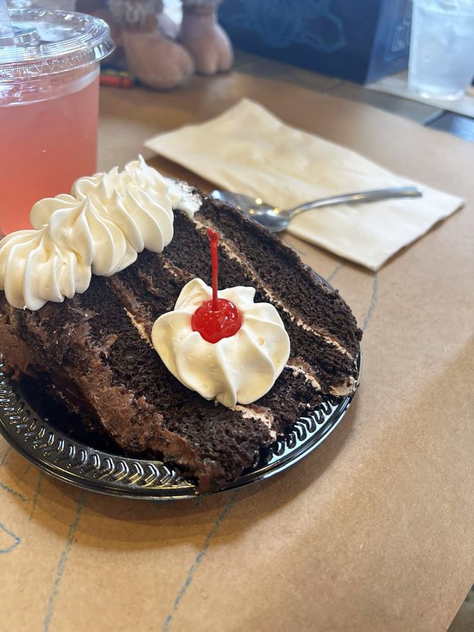 A slice of chocolate cake with a cherry on top – because after conquering a fortress of crab shells, you've earned every decadent forkful.