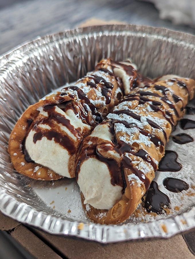 These cannolis aren't just dessert – they're the sweet encore after your pizza concert, with chocolate drizzle playing the final delicious note.