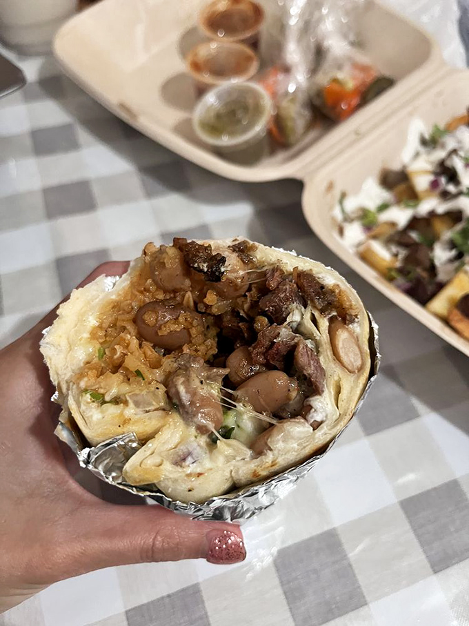 Wrapped in foil like the precious gift it is. This burrito's cross-section reveals the careful layering that makes every bite balanced perfection.