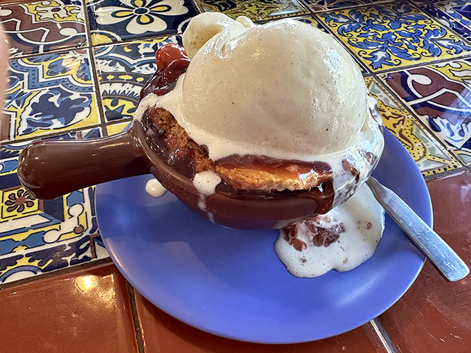 This isn't just dessert; it's a warm cherry cobbler topped with ice cream melting into all the right places – the perfect sweet finale.