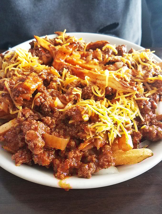 Chili cheese fries that laugh in the face of diet plans—a glorious mess that demands to be shared but rarely is.