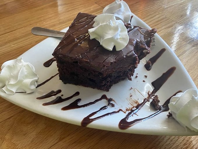 A chocolate cake so rich it should come with its own tax bracket. Those dollops of whipped cream aren't garnish – they're necessary indulgence.