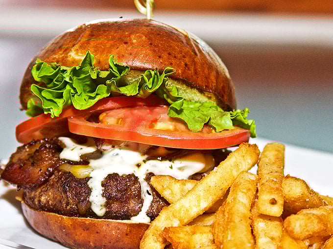 This isn't just a burger—it's a masterpiece of melted cheese, fresh vegetables, and perfectly seared beef on a toasted brioche throne.