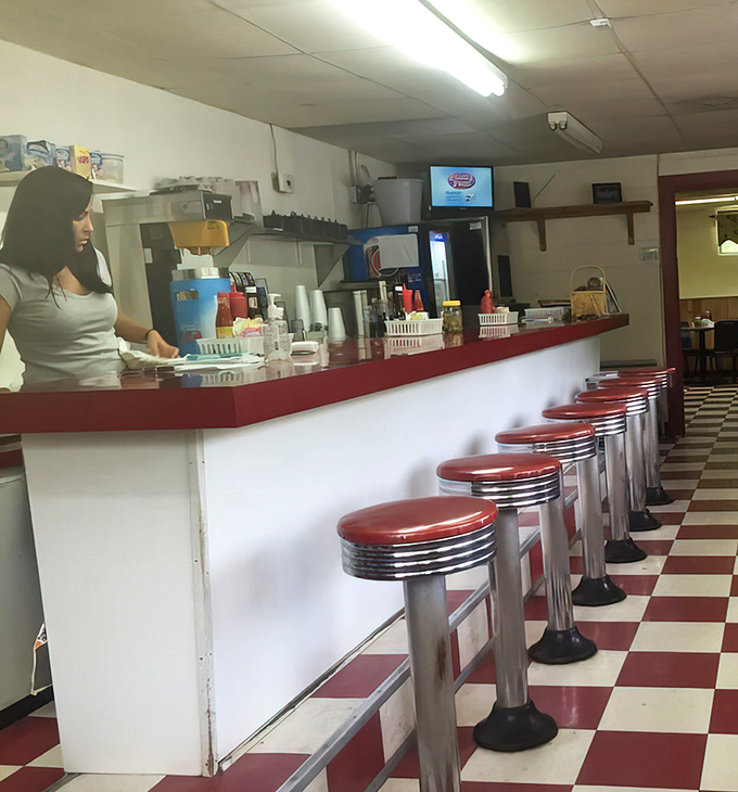 Those gleaming counter stools aren't just seating—they're front-row tickets to the breakfast show, where regulars hold court and newcomers become family.