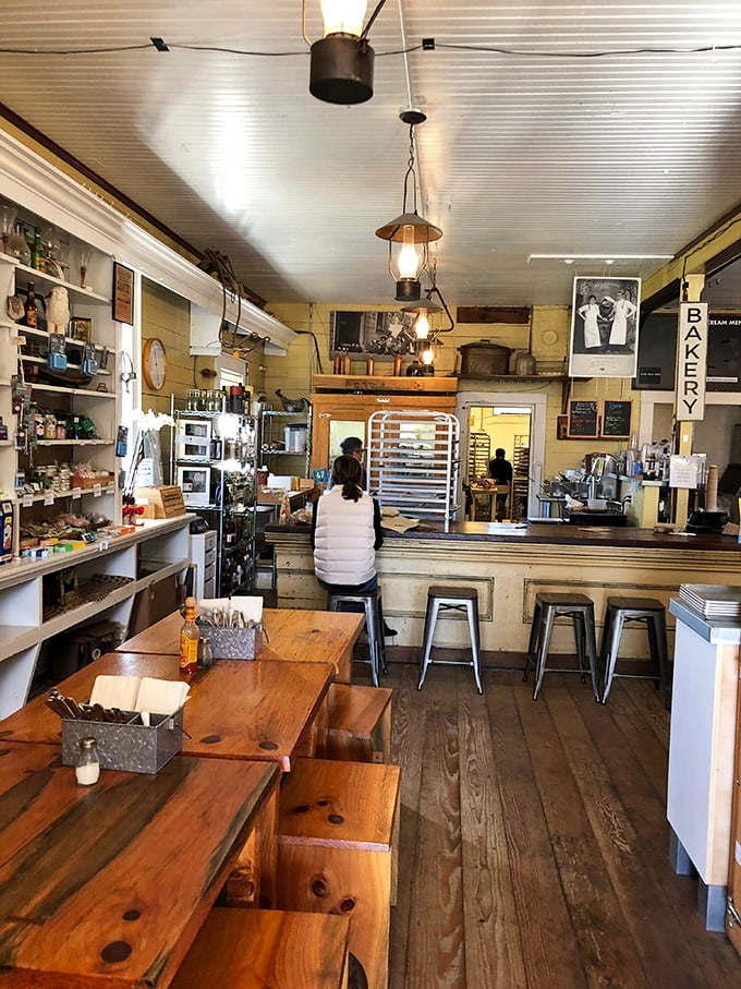 The heart of the operation – where sandwiches are born and coffee flows freely under the watchful glow of vintage lanterns.