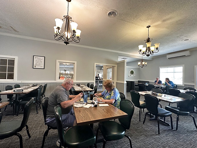 Diners enjoying their meals in peaceful surroundings, under soft chandelier light. No phones in sight—just people connecting over food that demands your full attention.