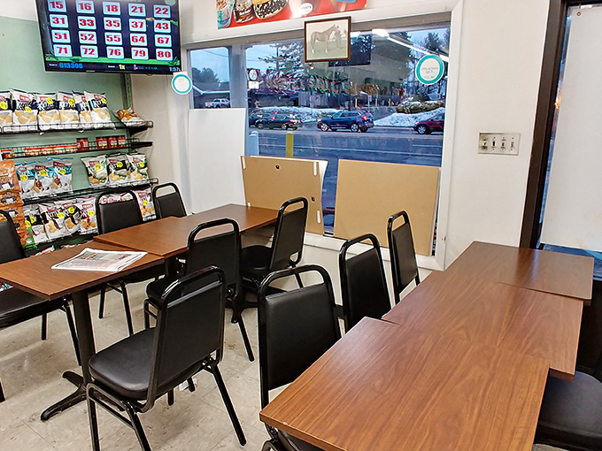 The modest dining area – where sandwich dreams come true under the watchful eye of lottery numbers. Simple seating for serious eating. 