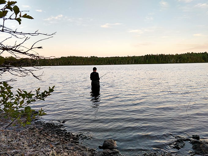 Patience meets persistence as an angler tests Lake Superior's waters. On Isle Royale, fishing isn't just an activity—it's a meditation practiced standing up.