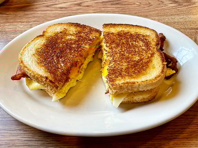 The humble grilled cheese, elevated to art form. That golden-brown exterior gives way to a molten center that makes you question why anyone eats anything else.