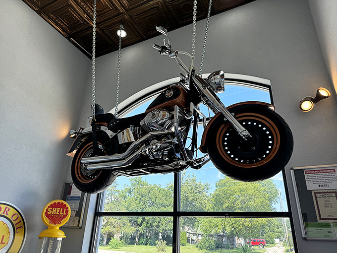 That's not just decoration—it's a motorcycle with the best seat in the house, suspended in mid-air like a chrome guardian angel.