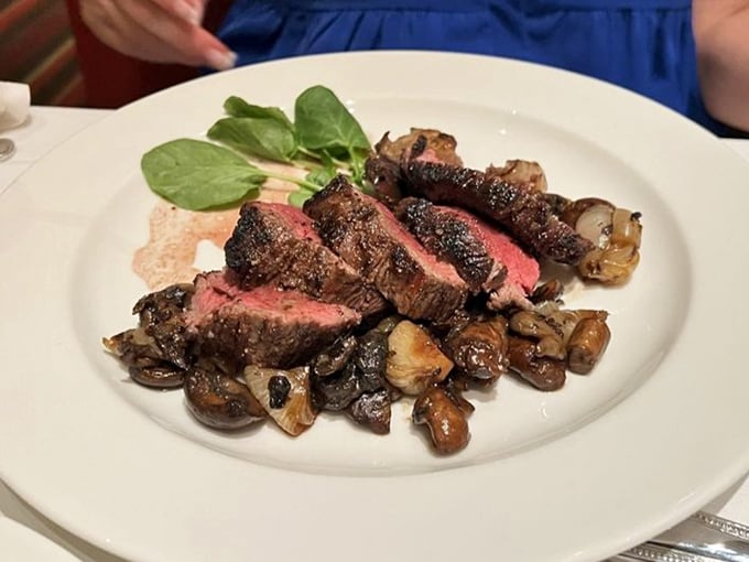 Sliced steak revealing that perfect pink center. The mushrooms aren't sidekicks—they're essential supporting actors in this meaty drama.