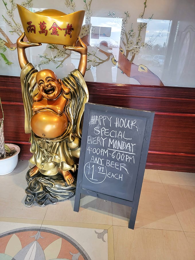 A laughing Buddha statue guards the happy hour sign—because even enlightenment is easier to achieve with $1.99 beer on Mondays.