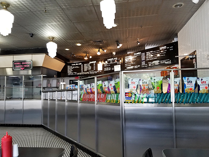 The counter view – where anticipation builds as you scan the menu. Every great cheesesteak experience begins with this moment.