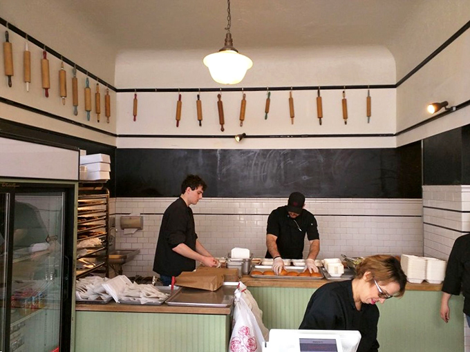 Behind the scenes where the magic happens—rolling pins hanging like trophies above a workspace where simplicity meets excellence.