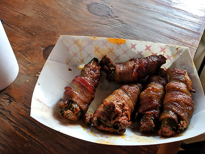 Bacon-wrapped jalapeños—where smoke meets heat in a perfect union that makes you wonder why all vegetables don't come wrapped in pork.