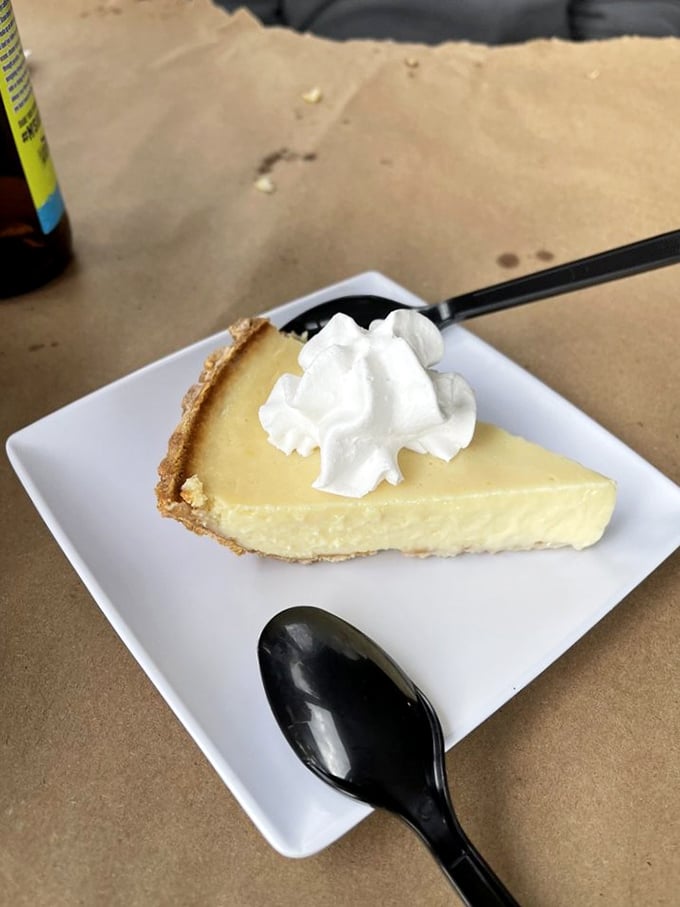 The holy grail of Florida desserts – key lime pie with that perfect yellow hue that screams authenticity, topped with a cloud of whipped cream that makes everything right in the world.