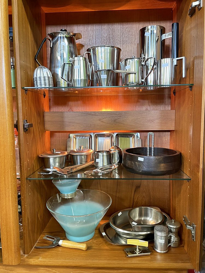 Mid-century serving pieces gleaming on wooden shelves—ready to elevate your next cocktail party from "we bought plastic cups" to "we have actual martini glasses."