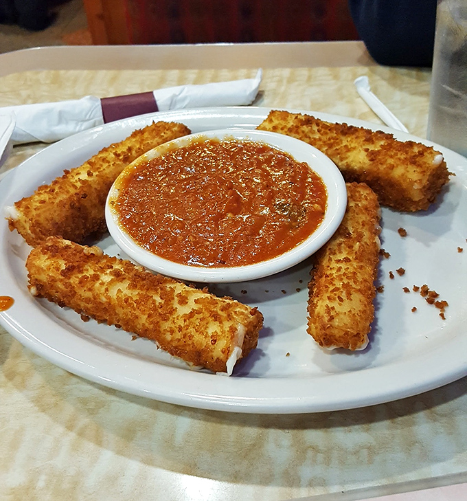 Mozzarella sticks—the golden guardians of marinara lake, crispy on the outside with that perfect cheese-pull moment that makes life worth living.
