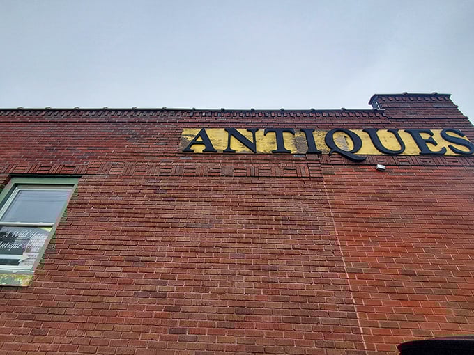 The "ANTIQUES" sign stands like a beacon for treasure hunters. It might as well say "YOUR NEXT CONVERSATION PIECE IS HERE."