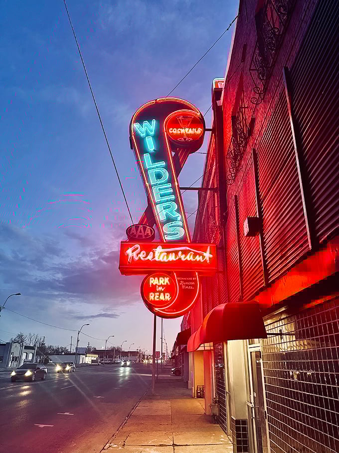 As twilight falls, the neon sign transforms from advertisement to art installation. "Cocktails" and "Park in Rear" – two phrases that promise a good time.