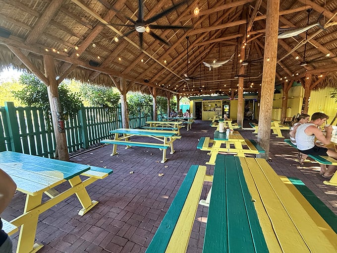 The outdoor dining area feels like eating in a friend's backyard—if your friend had the best food in the Keys and picnic tables painted in paradise colors.