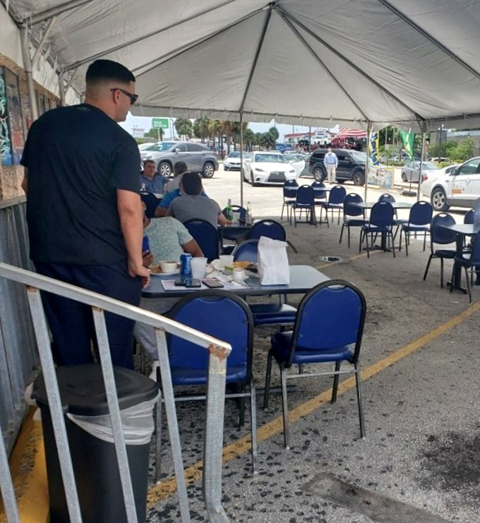 Outdoor dining under a simple tent – because great seafood needs no fancy setting. Island vibes and satisfied diners prove atmosphere comes from the plate.