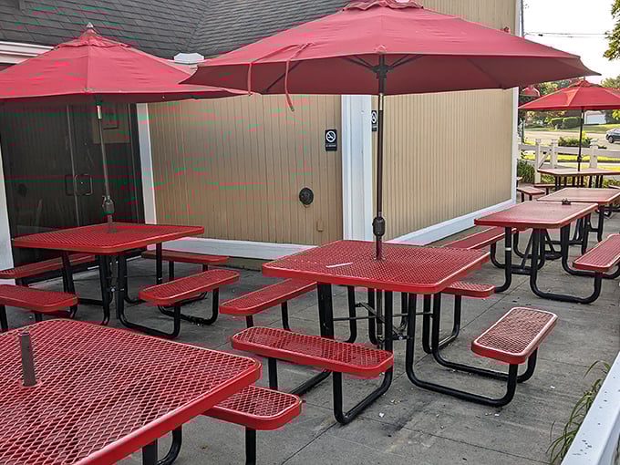 Red picnic tables under matching umbrellas create an outdoor oasis for enjoying smoky treasures while the Ohio breeze carries tempting aromas to passersby.