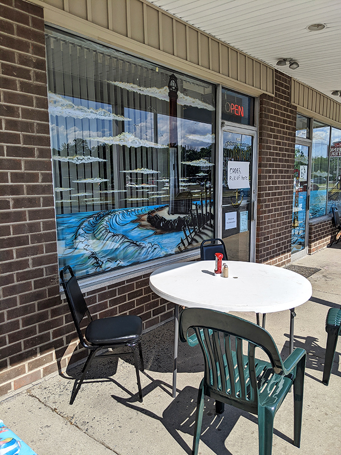 Outdoor seating offers an alternative dining option. The painted window mural brings coastal vibes to this landlocked seafood haven.