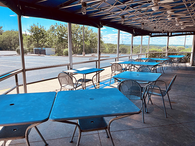 The covered patio with bright blue tables offers al fresco dining with a view – because barbecue somehow tastes even better with a side of fresh air.