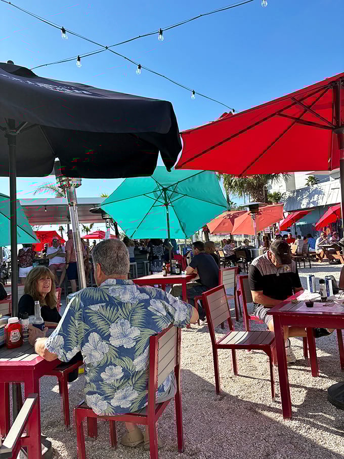 Outdoor dining under colorful umbrellas, where Hawaiian shirts are the uniform and conversations flow as freely as the cocktails on a perfect Florida afternoon.