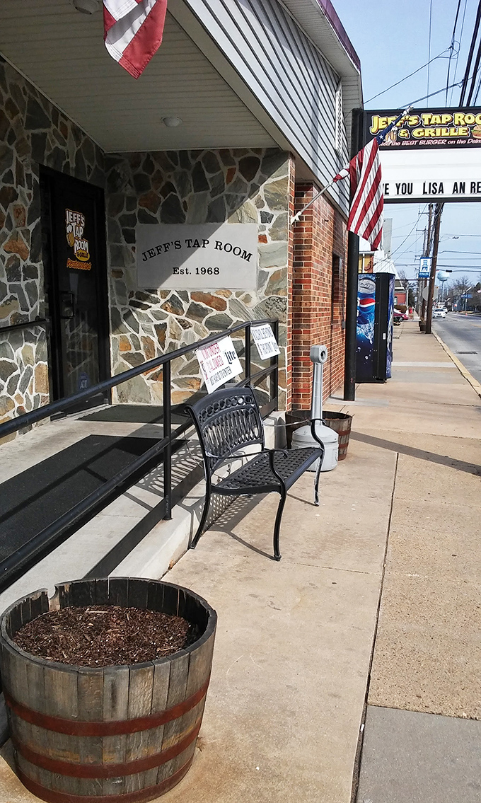 A slice of Americana with stone facade and American flag. That bench outside isn't just seating—it's where you'll contemplate your next visit.