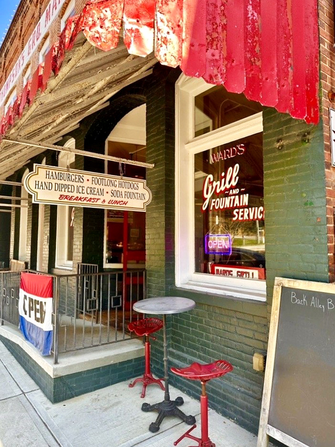 The entrance that's welcomed hungry visitors for generations. Those red stools outside aren't just seating—they're front-row tickets to Main Street's parade of life.