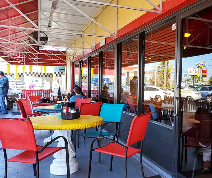 The outdoor seating area pops with primary colors, offering a cheerful spot to digest your breakfast feast while planning your inevitable return.