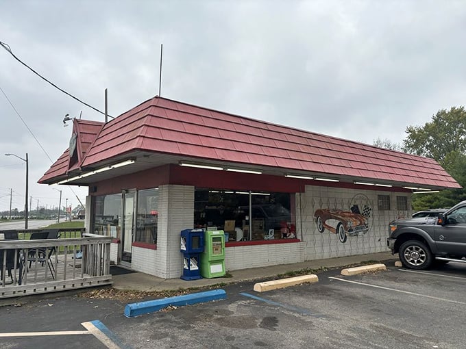 Even from the outside on a cloudy day, that distinctive red roof beckons like a lighthouse for the breakfast-starved. The vintage car mural hints at the time warp waiting inside.