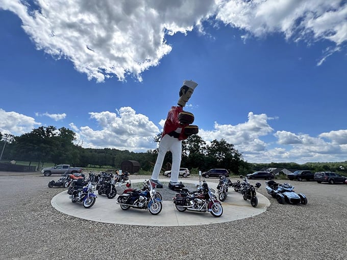 Even the motorcycles seem to pay homage to the towering chef statue, circling him like chrome pilgrims at this shrine to roadside Americana.