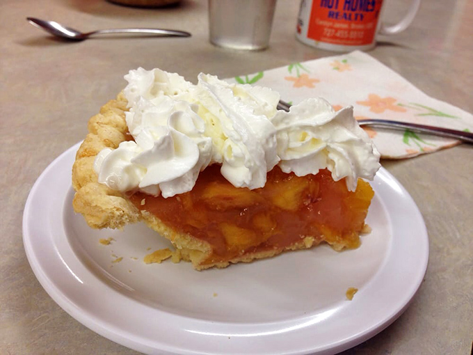 Peach pie crowned with whipped cream clouds – because sometimes breakfast dessert is the most important meal decision.