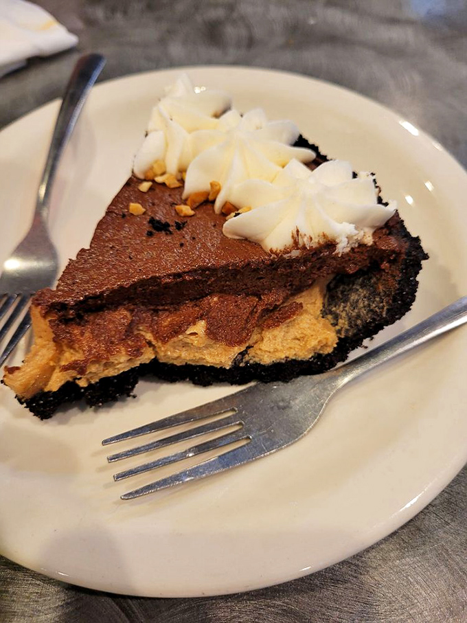 Chocolate and peanut butter pie with an Oreo crust—proof that sometimes the best things in life come in triangular form on small white plates.