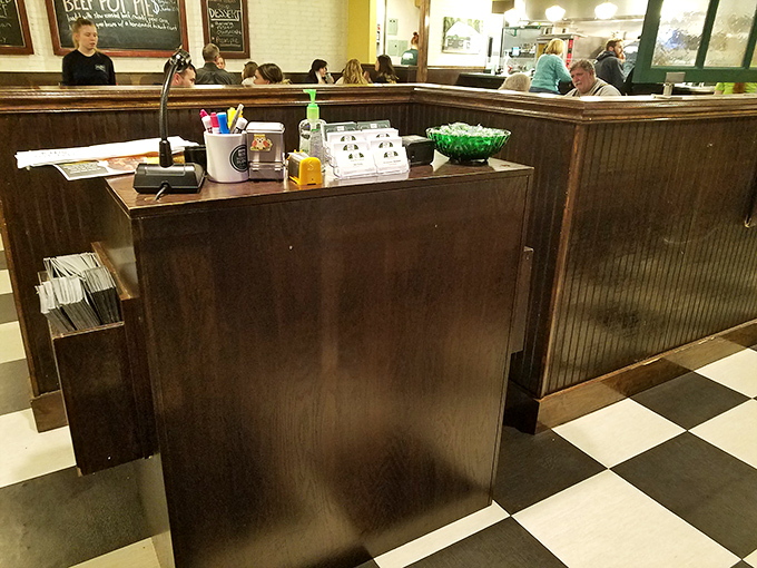The host station – first checkpoint on your journey to comfort food nirvana. That bowl of mints isn't just courtesy, it's a promise.
