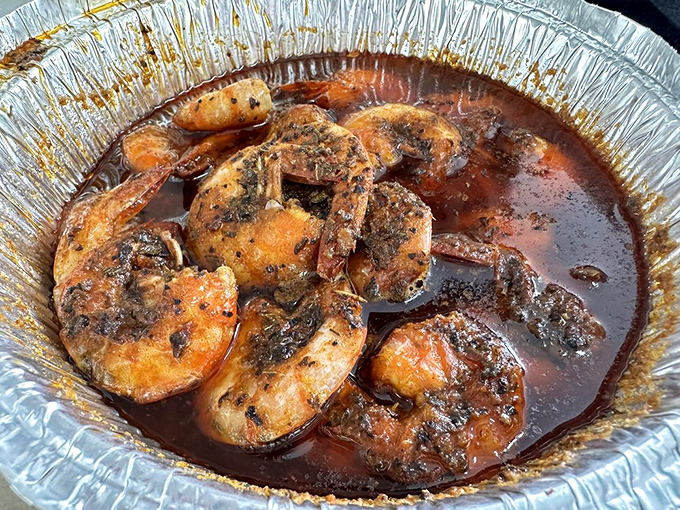 These glistening shrimp swimming in savory sauce aren't just dinner – they're an invitation to roll up your sleeves and get deliciously messy.