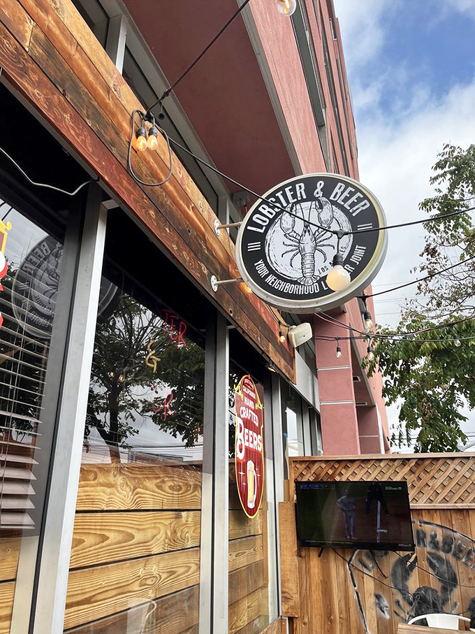 The circular sign promises exactly what awaits inside—no false advertising here, just lobster and beer in your neighborhood.