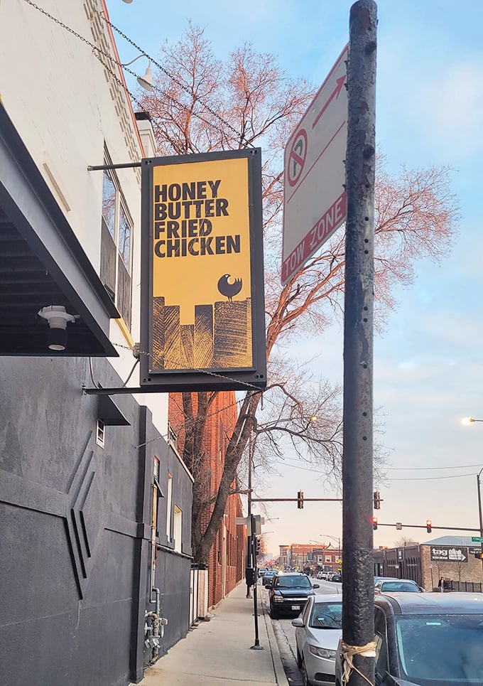 The iconic yellow sign swinging above the sidewalk, a North Star for fried chicken pilgrims navigating the streets of Avondale.