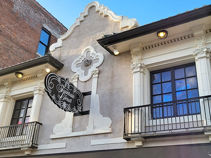 The Fountain's vintage signage hangs like jewelry on the historic façade, a stylish announcement that timeless pleasures await within.