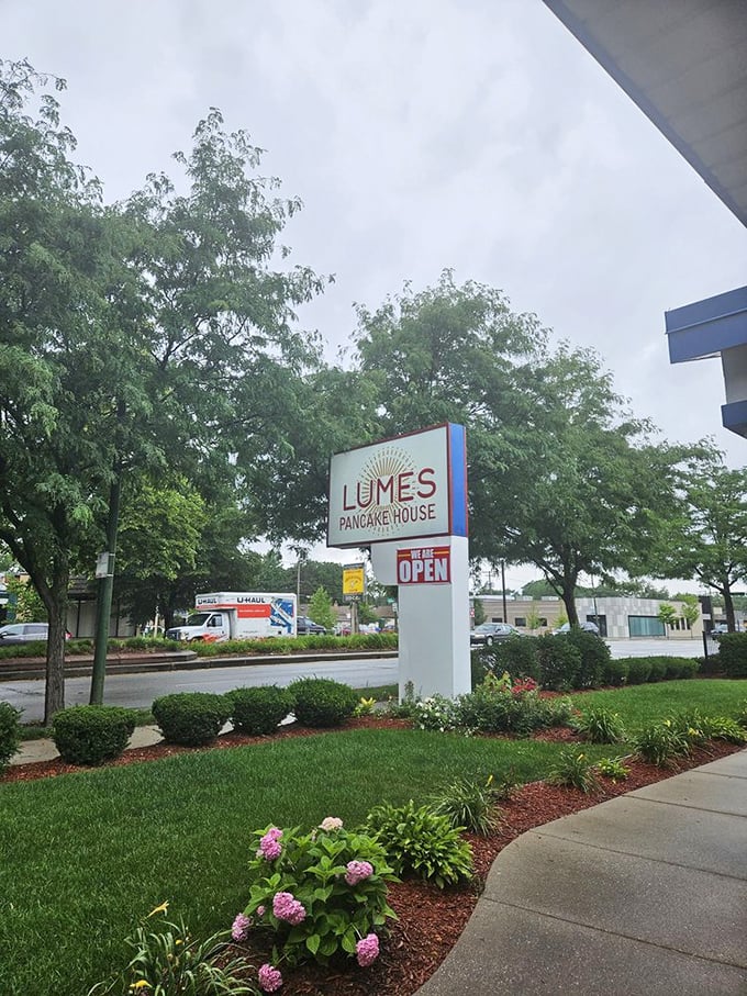 Rain or shine, the Lumes sign stands ready to guide hungry breakfast seekers to their pancake destination—like a carb-loaded North Star.