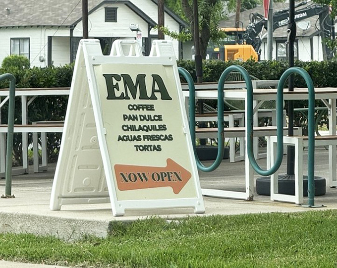 The sidewalk sign doesn't just announce "EMA"—it promises coffee, pan dulce, and chilaquiles, the holy trinity of morning happiness in Houston.