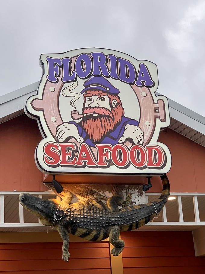 That iconic sign with its pipe-smoking sailor and obligatory alligator—Florida's seafood identity summed up in one perfectly kitschy display.