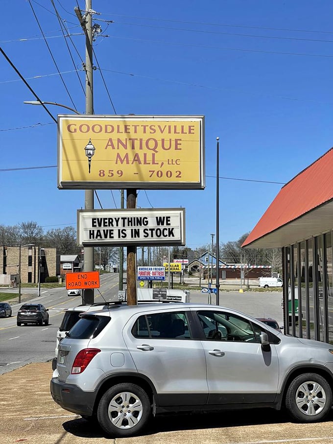 The roadside sign promises "EVERYTHING WE HAVE IS IN STOCK" – a charmingly obvious statement that perfectly captures the straightforward appeal of this antique wonderland.