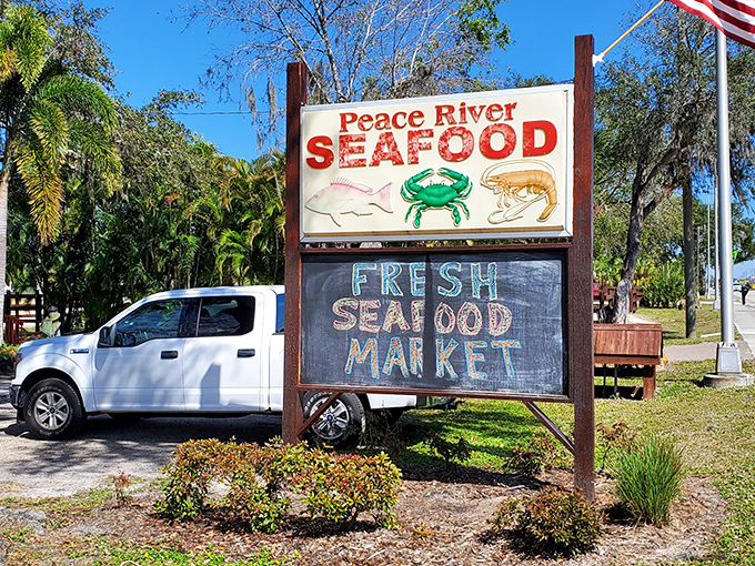 The sign doesn't just mark a restaurant—it's a beacon for seafood pilgrims who've heard the gospel of Peace River's blue crab and come to worship.
