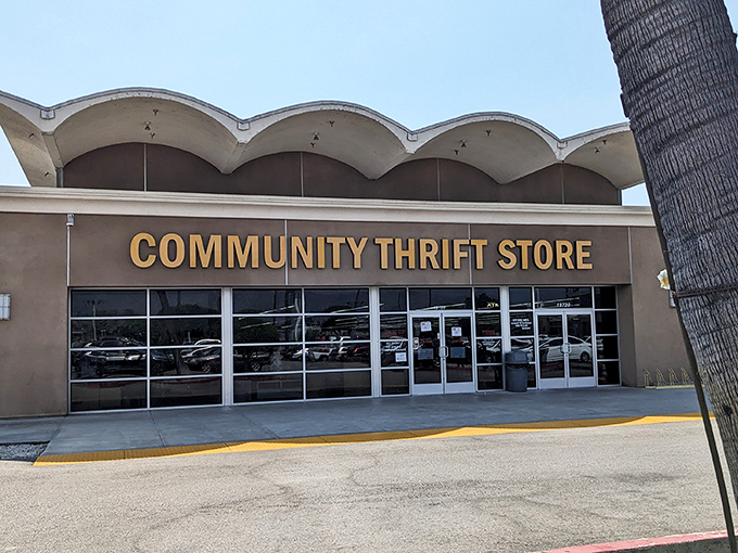 By day, the distinctive wavy roof and desert-toned exterior blend perfectly with the Southern California landscape—a temple of thrift under palm tree sentinels.
